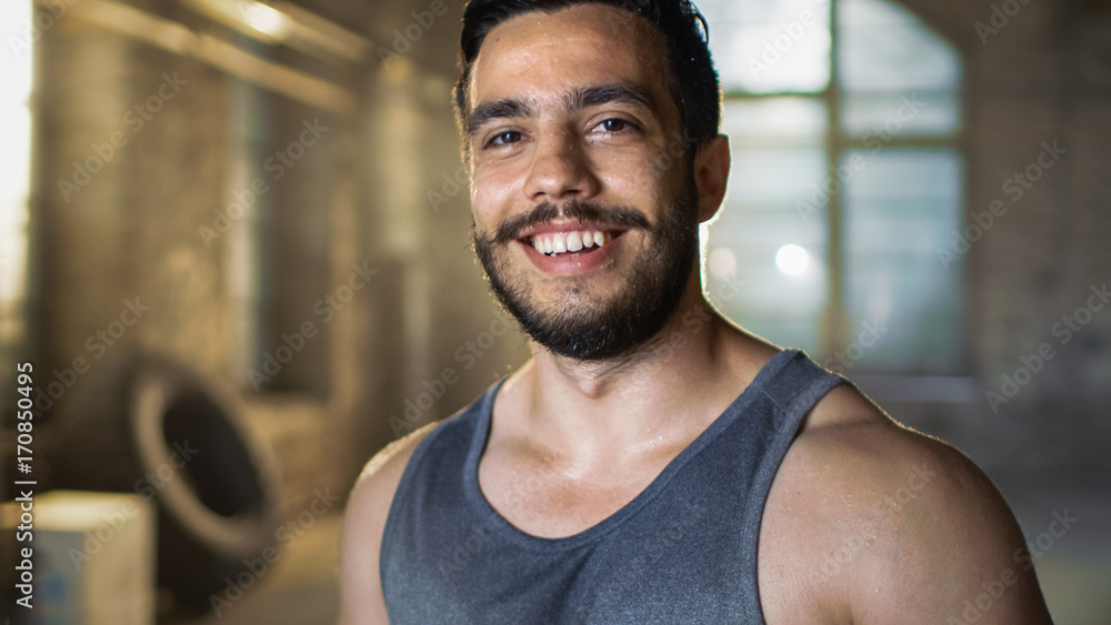 Handsome Sweaty Muscular Man Smiles on Camera. Sweat is dripping from ...