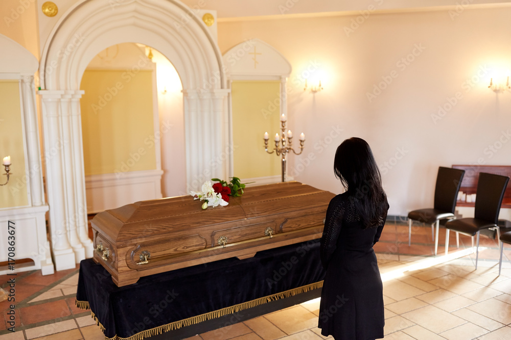 sad woman with coffin at funeral in church Stock Photo | Adobe Stock