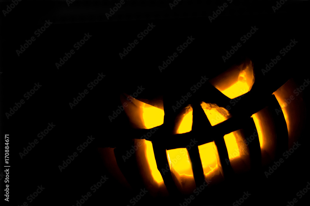 Sinisterly glowing eyes and teeth from a carved pumpkin on halloween in ...