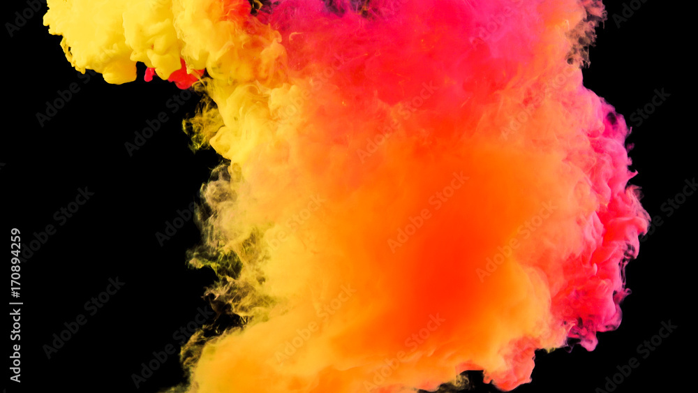 Colorful rainbow paint drops from above mixing in water. Ink swirling ...