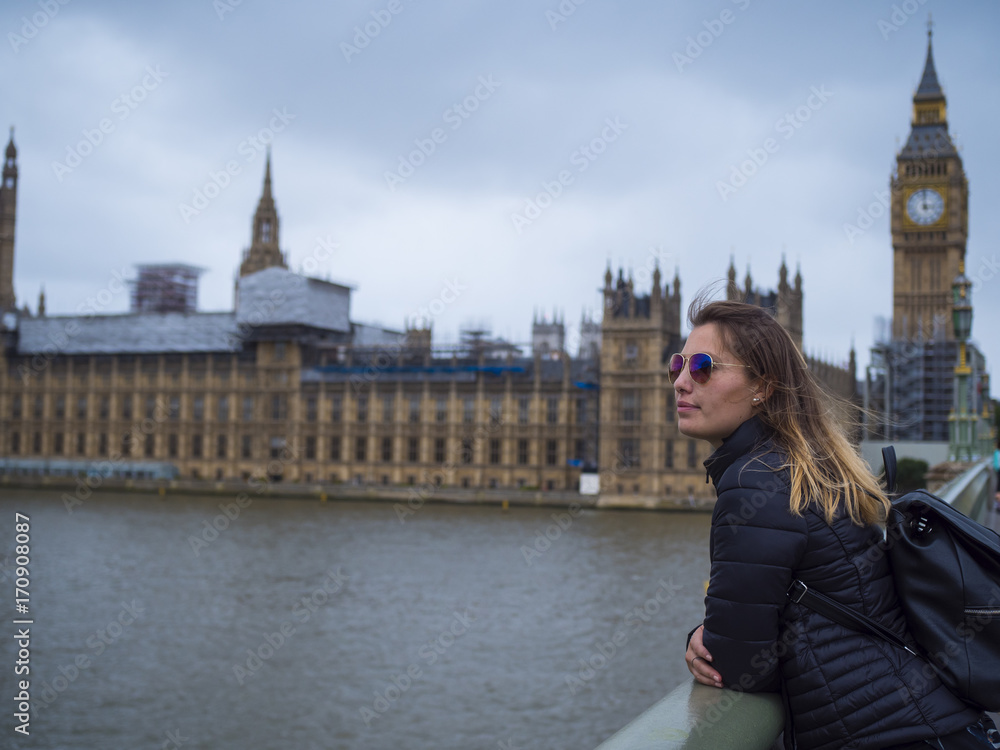 Poster Young blonde girl in London - Westminster Bridge and Houses of ...