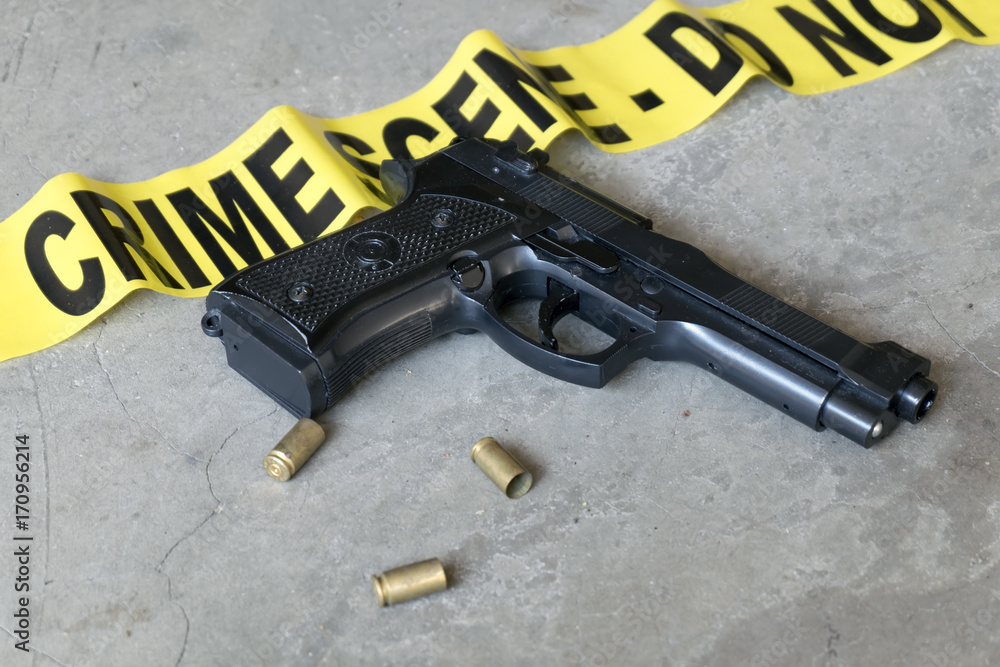 Crime scene concept black gun with casings Stock Photo | Adobe Stock