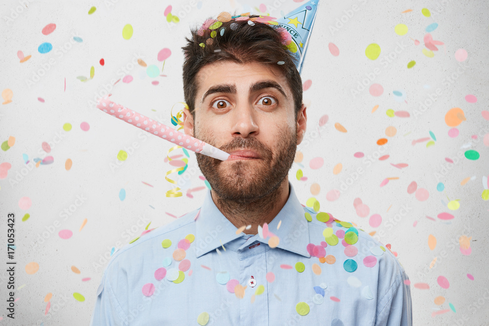Horizontal shot of attractive unshaven young man wearing formal shirt ...