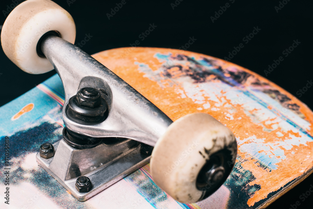 Skateboard parts on black background, rubbed deck and wheels on truck ...