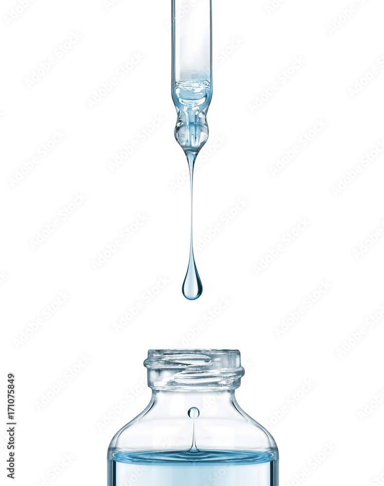Drop falls from a pipette into a cosmetic bottle on white background ...