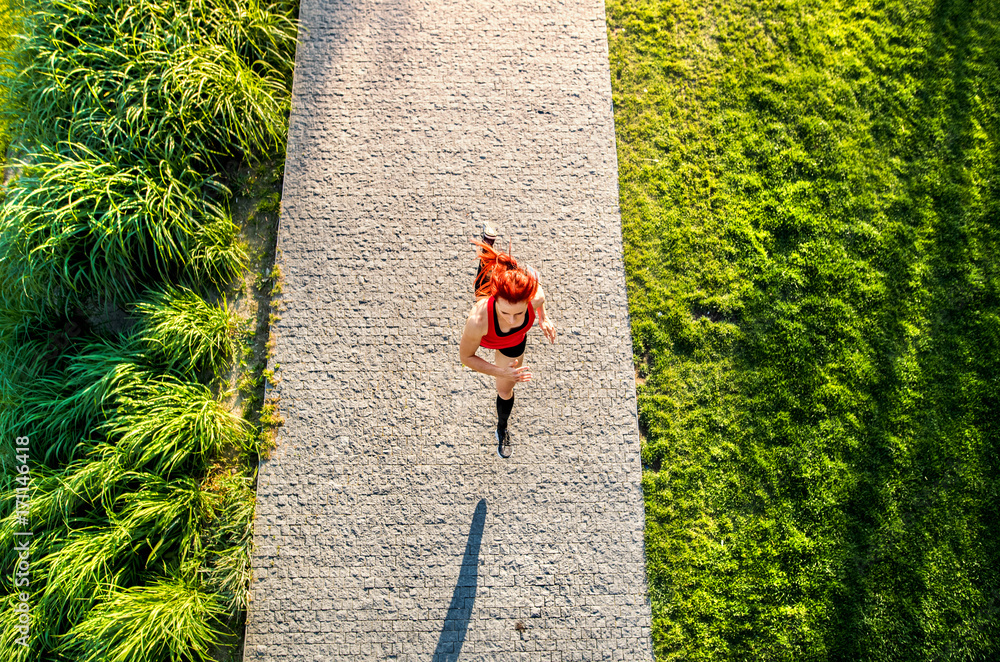 Beautiful young athlete running on a path in park. Stock Photo | Adobe ...