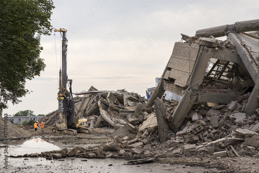 Collapsed industrial buildings with machine driller Stock Photo | Adobe ...