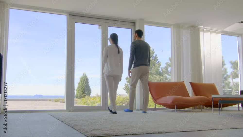 Beautiful Young Couple In Their Newly Purchased House, They Look at the ...