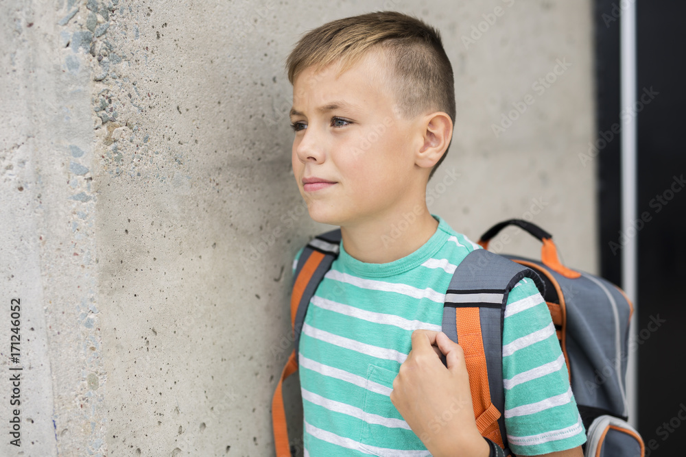 Pre teen boy outside at school Stock Photo | Adobe Stock