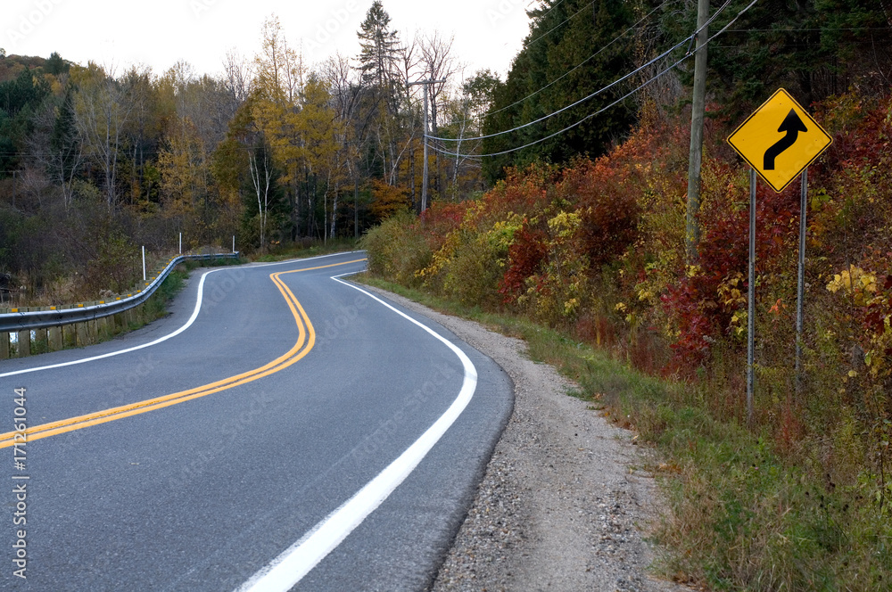 Yellow Road Sign and Curved Road Stock Photo | Adobe Stock