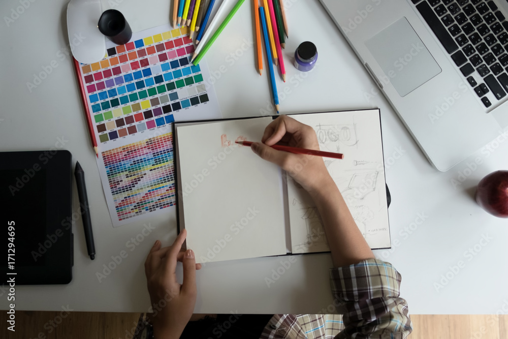 woman artist drawing something on at the creative office, graphic ...