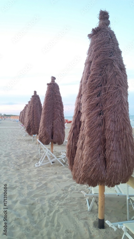 ombrelloni chiusi in spiaggia Stock 写真 | Adobe Stock
