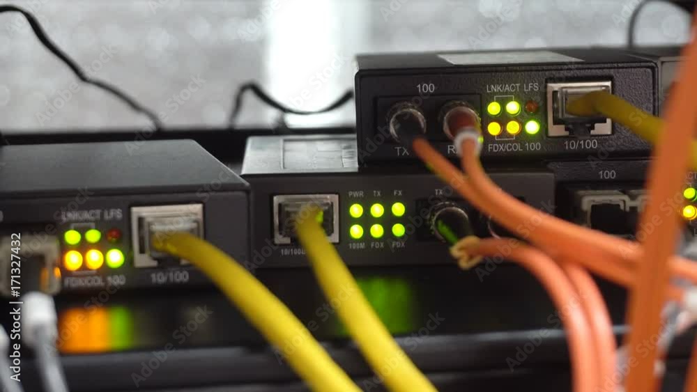 Details from loaded and working network switch with fiber media converter(focus light status ...