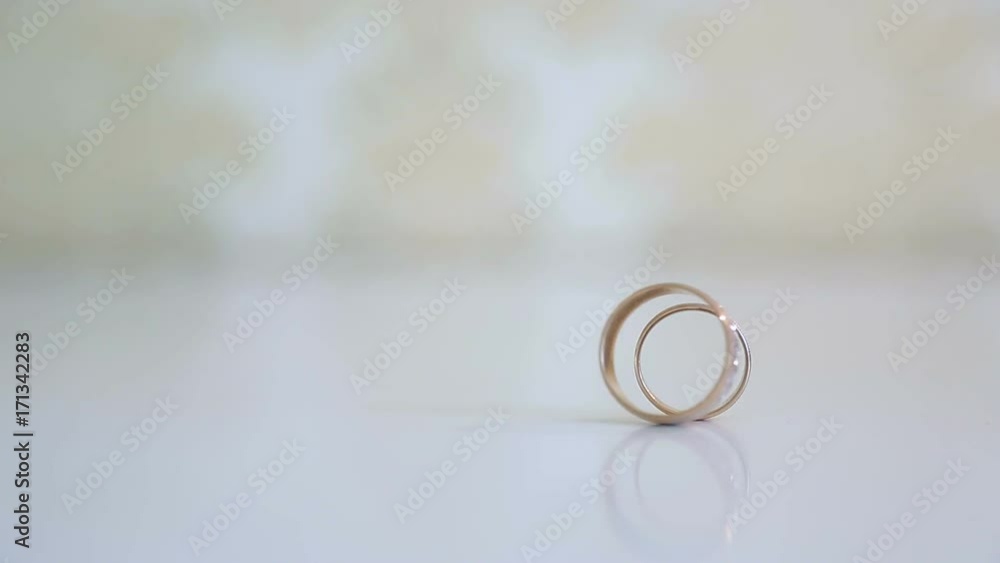 Unique case. Two wedding rings hit one another and fall one on one ...