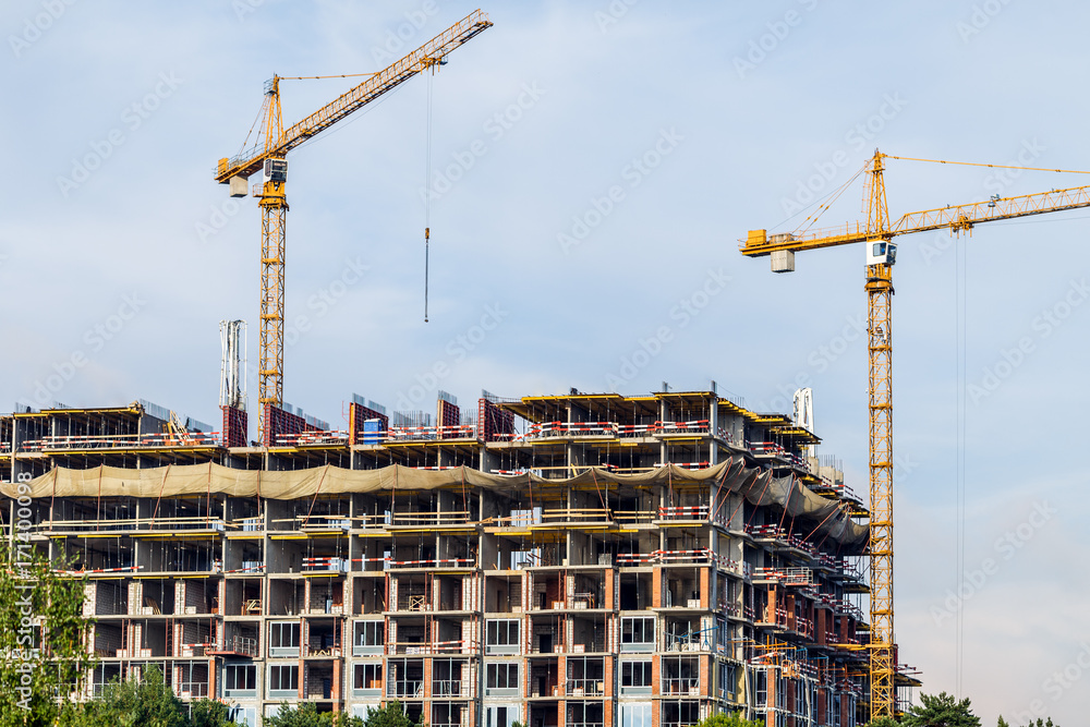 Crains on construction site of building Stock Photo | Adobe Stock