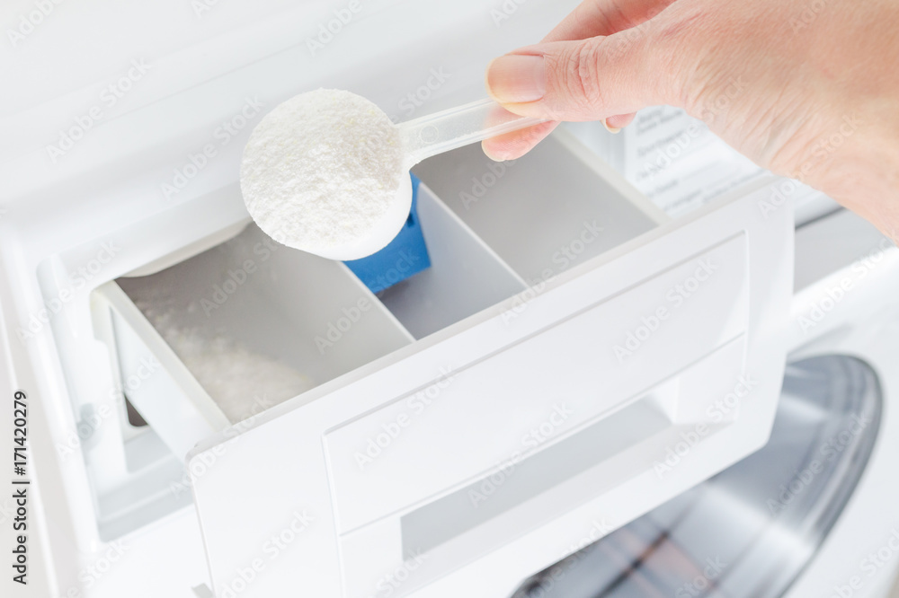 washing powder, detergent in a cup and womans hand, washing machine ...