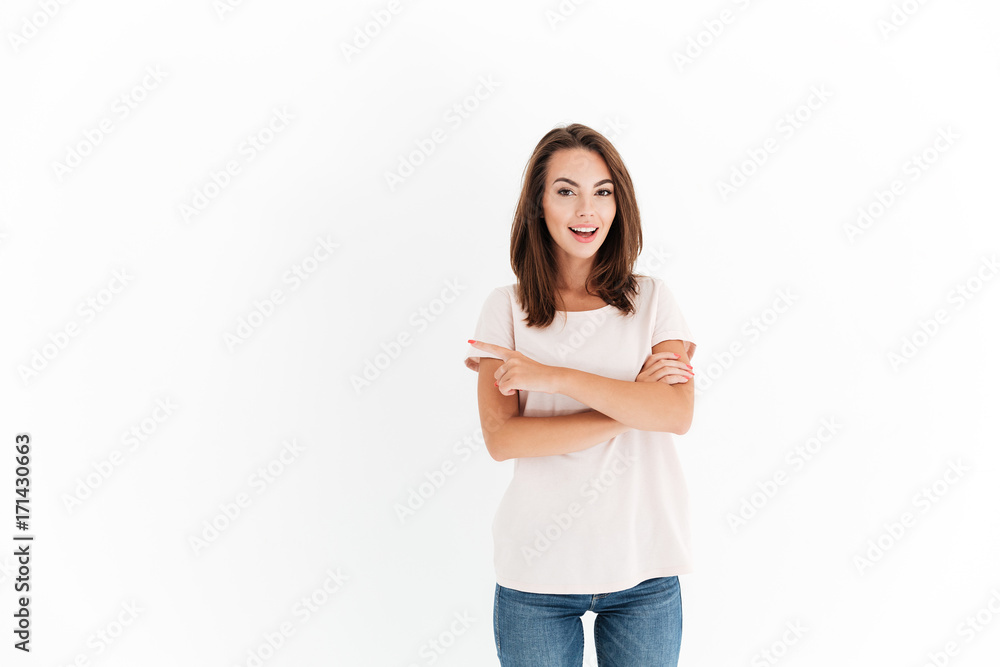 Smiling beauty woman with crossed arms pointing away Stock-Foto | Adobe ...