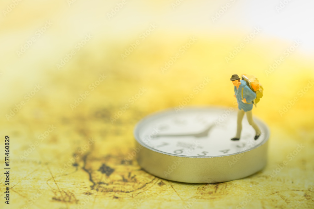 Travel and time concept. Traveler miniature people figure walking on ...