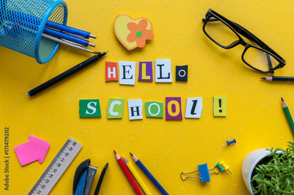 Hello School. Items for the school on a yellow table. Pupil outfit ...