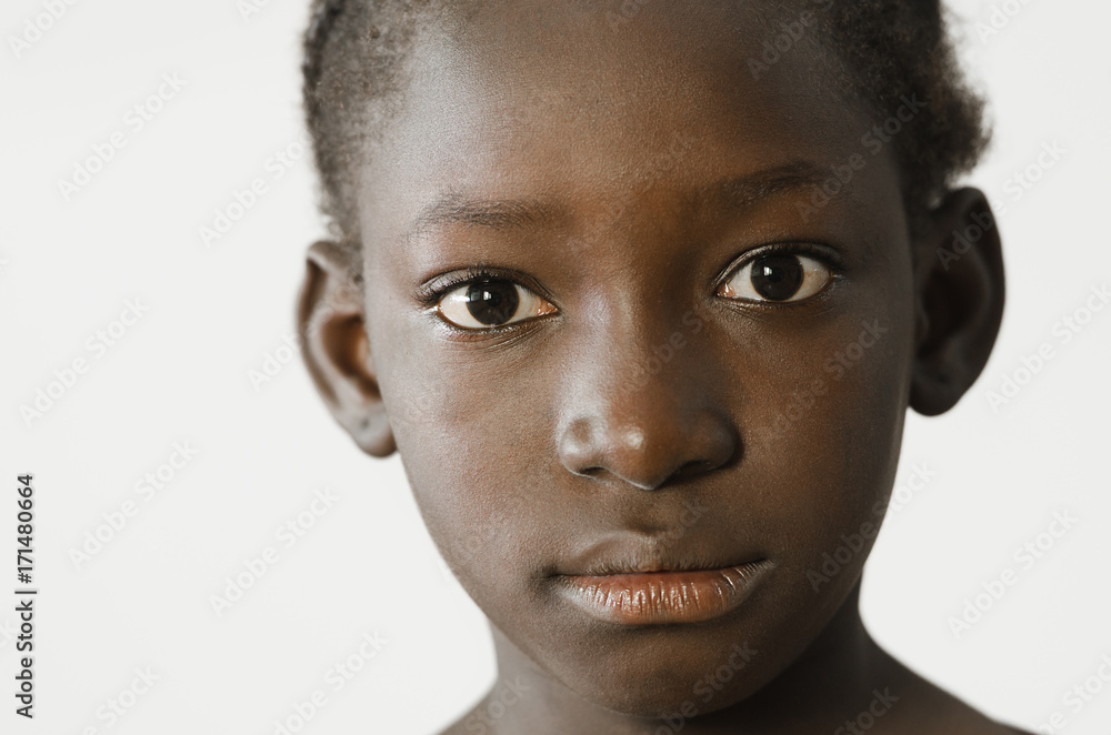 Sad African child showing her face for a portrait, sadness despair ...