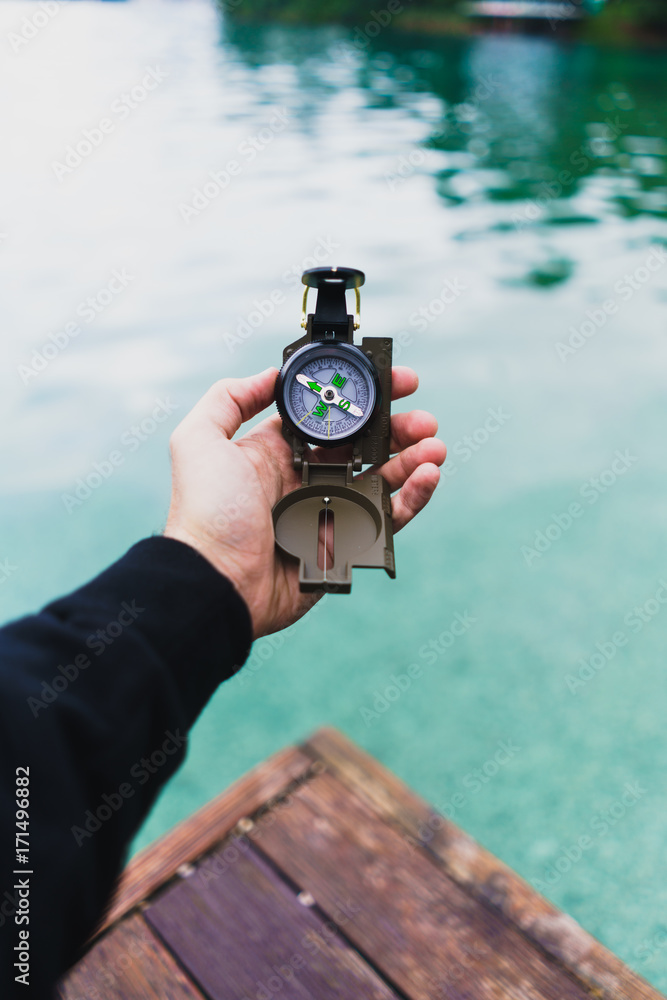 Crop male hand holding compass Stock Photo | Adobe Stock