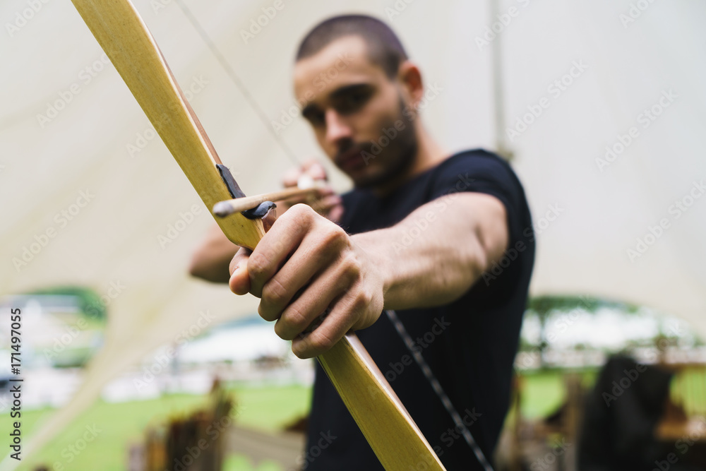 Man practicing archery in school Stock Photo | Adobe Stock