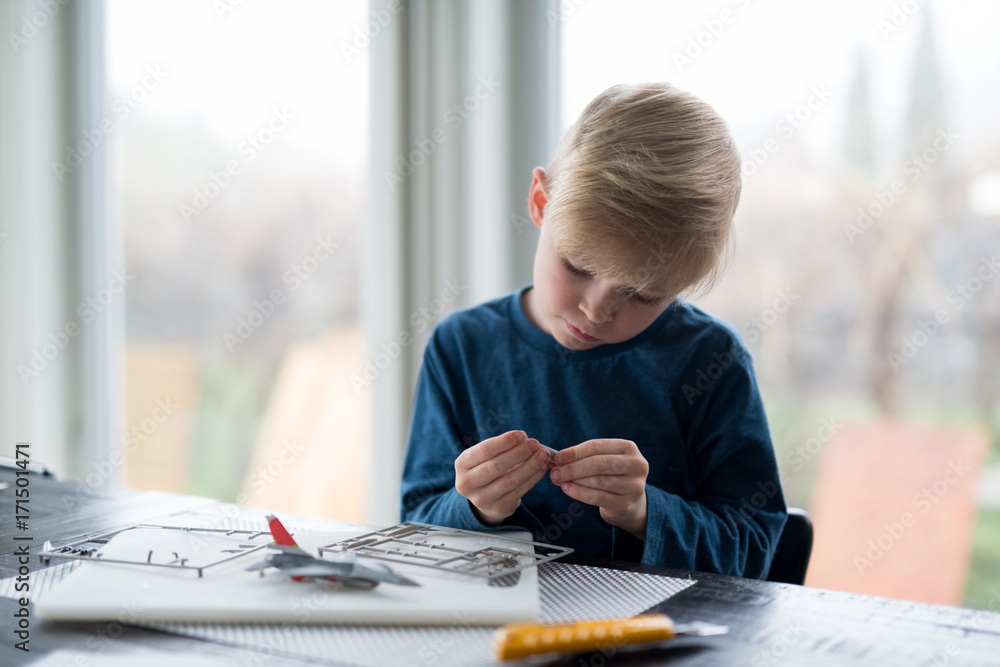 Little boy building model airplane Stock Photo | Adobe Stock