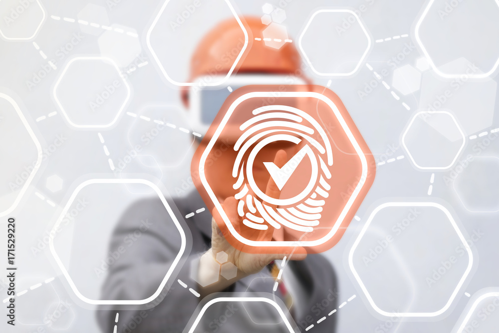 Man in hard hat and vr glasses presses fingerprint check mark button on ...