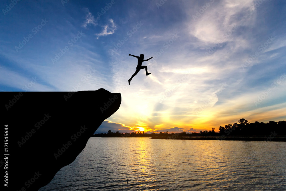 Man jump through the gap between hill.man jumping over cliff ...
