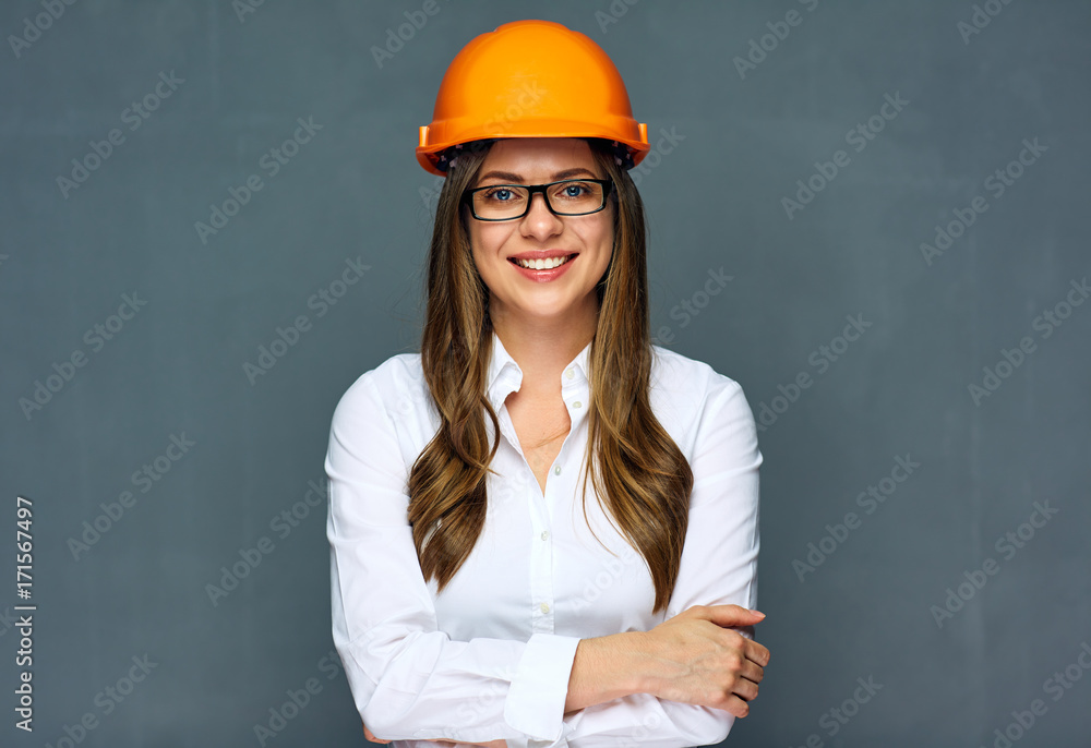 Smiling woman engineer wearing builder helmet. Stock Photo | Adobe Stock