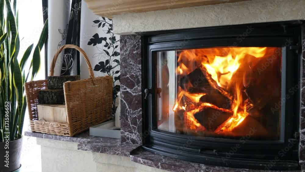 Firewood flames in the fireplace in a cozy house. Stock Video | Adobe Stock