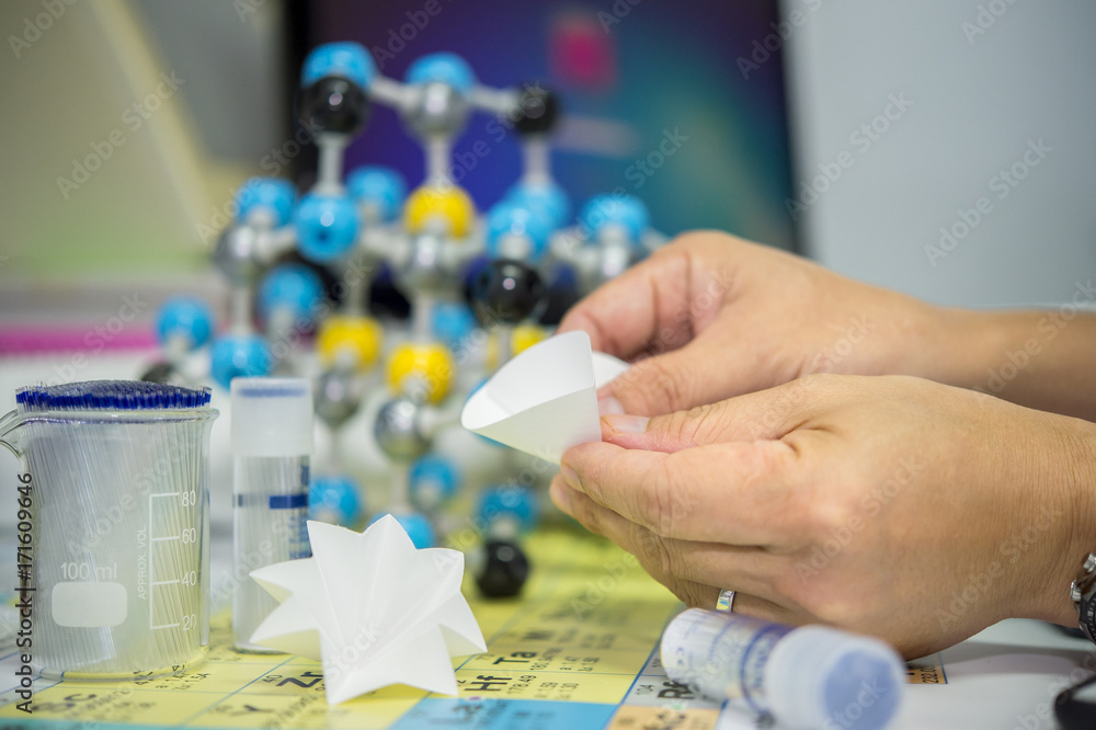 Scientists are folding filter paper for use in chemical filtration ...