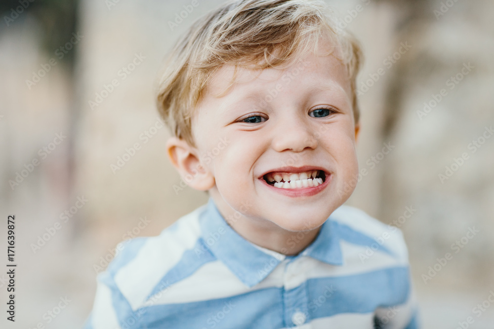 Cute little boy grinning and showing his teeth Stock Photo | Adobe Stock