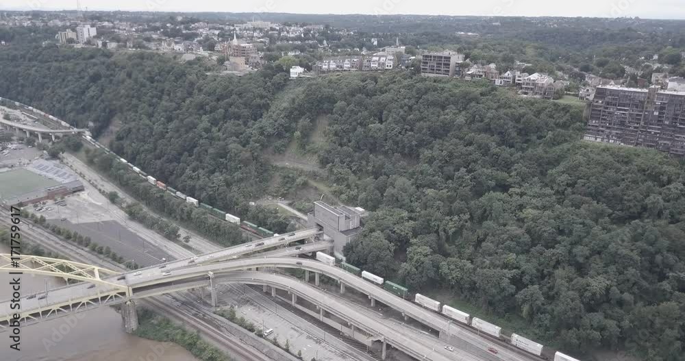 Approach of the Fort Pitt tunnel including views of a train and traffic ...