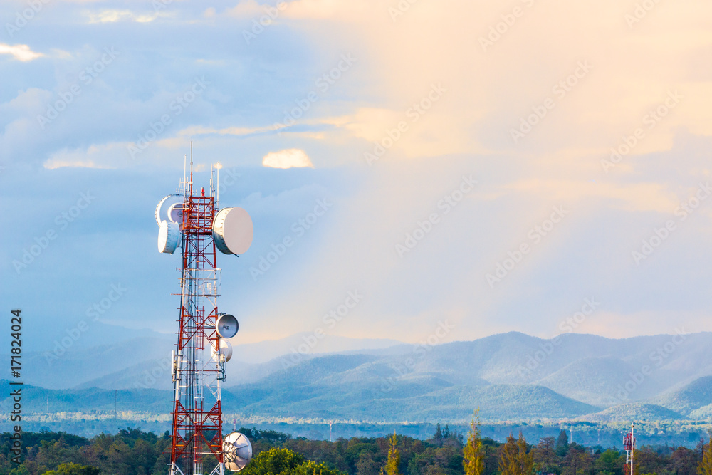 telecommunication tower with mountain range background with warm sunset ...