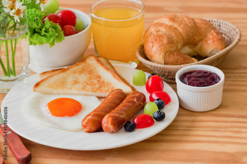 Homemade breakfast with sunny side up fried egg toast sausage fruits ...