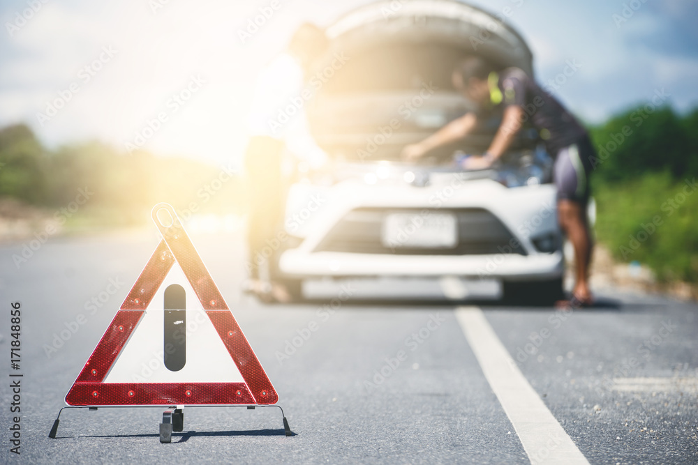 Emergency stop sign and man with broken car on the road Stock Photo ...