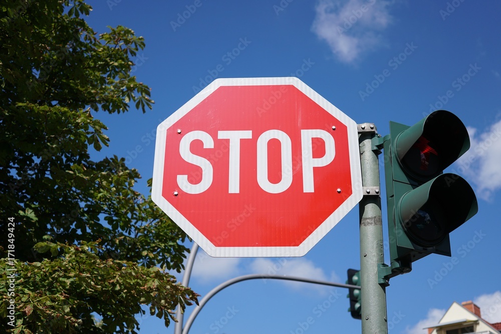 Stop sign with blue sky and a traffic light on background Stock Photo ...