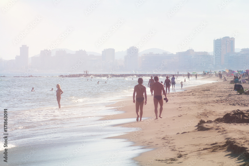 two guys in speedos walking around the beach Stock Photo | Adobe Stock