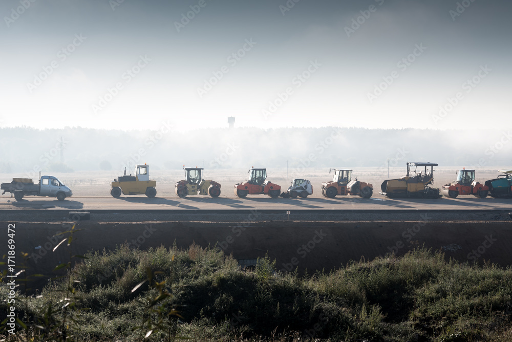 road under construction - wheel loader machine, pneumatic tyred roller ...