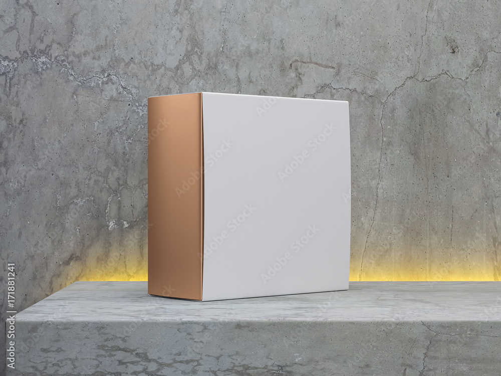 Square golden box packaging with white cover on concrete shelf with ...