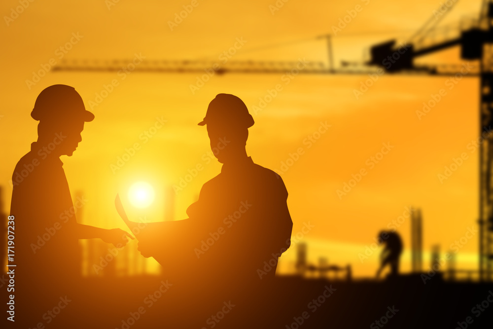 Silhouette of architect explaining the construction worker to the ...