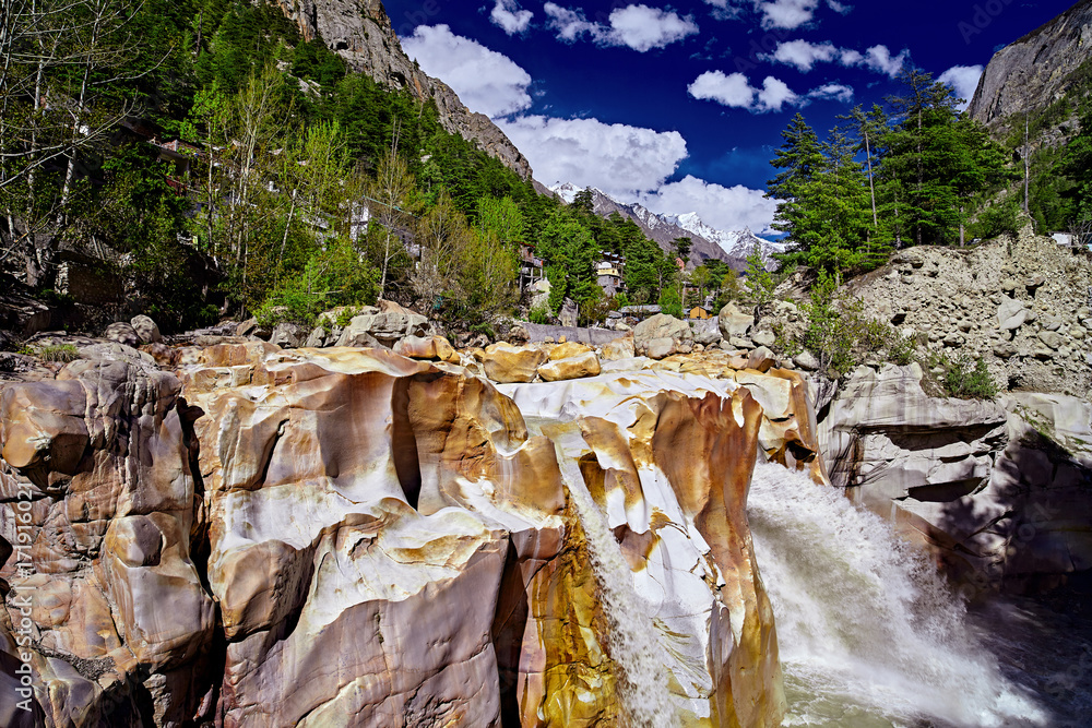 Waterfall of Ganges River flows across the Gangotri town. Uttarakhand ...