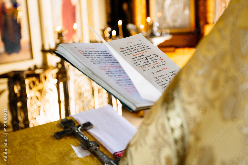 christian priest reading church book, priest reads a pray over the ...