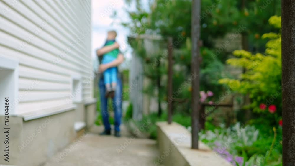 Boy running to his father's arms and hug him. Happy family concept ...