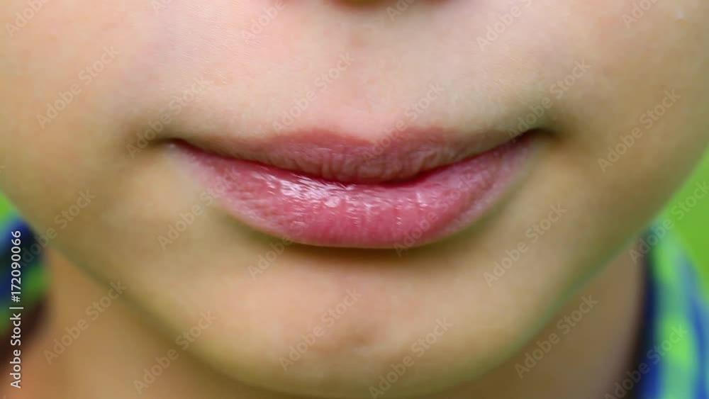 Closeup view of cute pink lips of young caucasian boy. Real time full ...