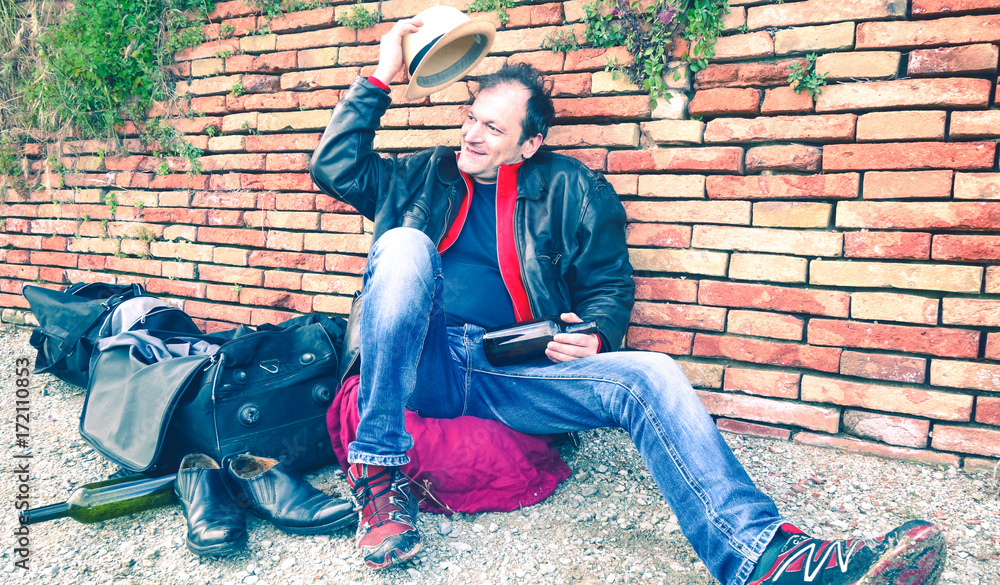 Homeless drunk man greets the day smiling with funny gesturing ...