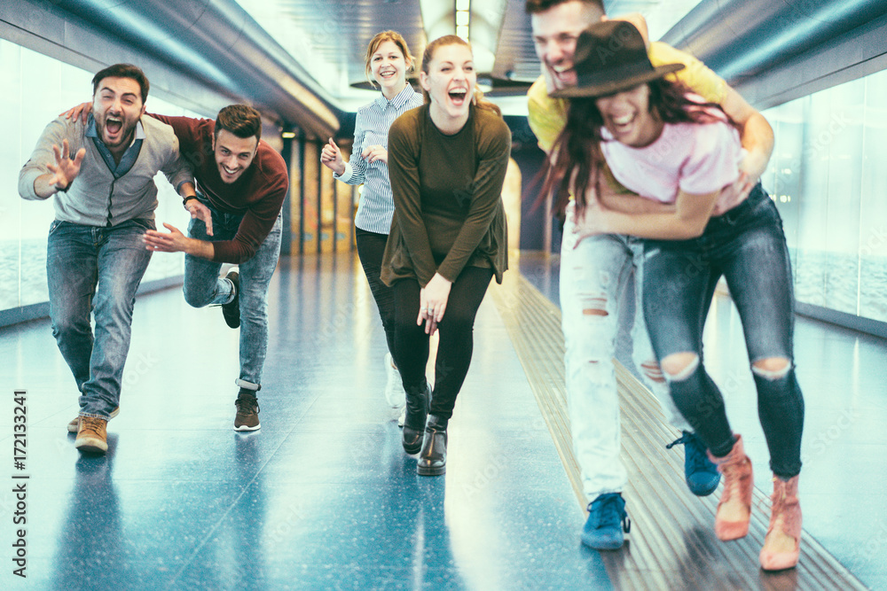 Happy friends having fun in underground metropolitan station - Young ...