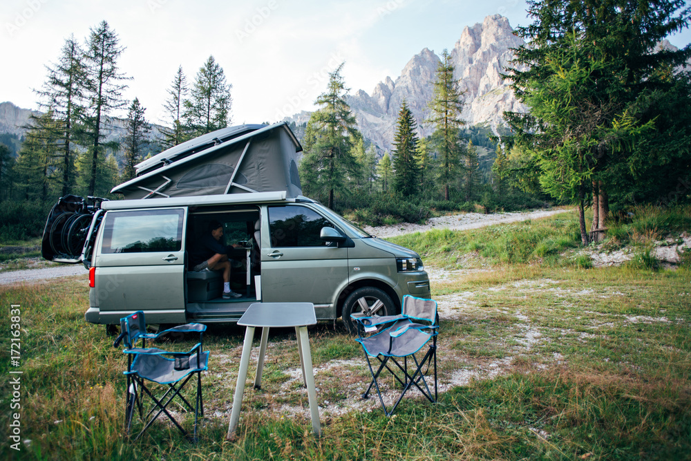 Small travel vehicle camping van or big car with folding rooftop with ...