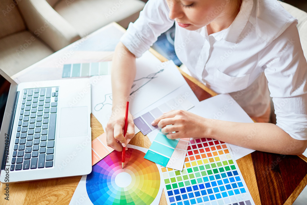 Creative designer pointing at color diagram while making choice from ...